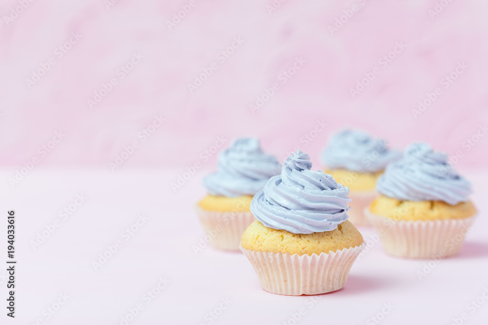 Cupcake decorated with violet buttercream on pastel pink background ...