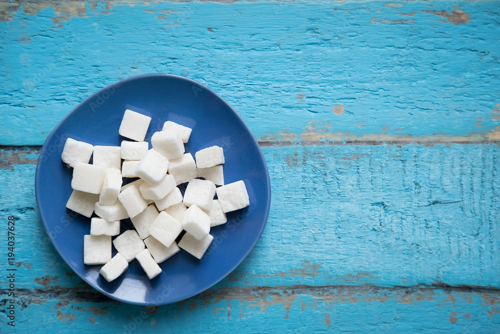 pressed sugar cubes sugar refined in a blue plate standing on a ...