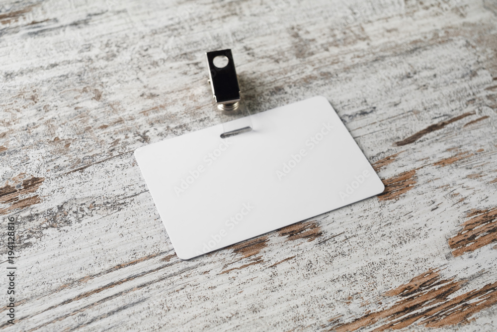 Blank plastic badge. Template for ID. White id card on wooden ...
