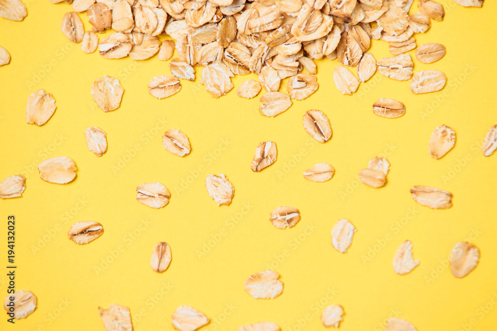 Yellow background. Many of oat flakes. Healthy eating Stock Photo ...