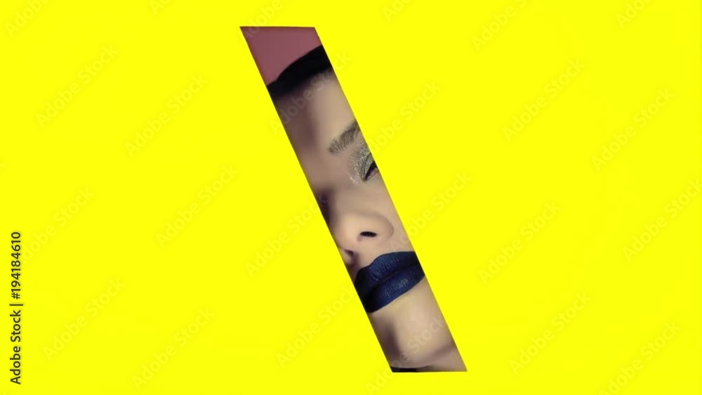 Face of girl in inclined slit in yellow paper background. Poses, turns ...