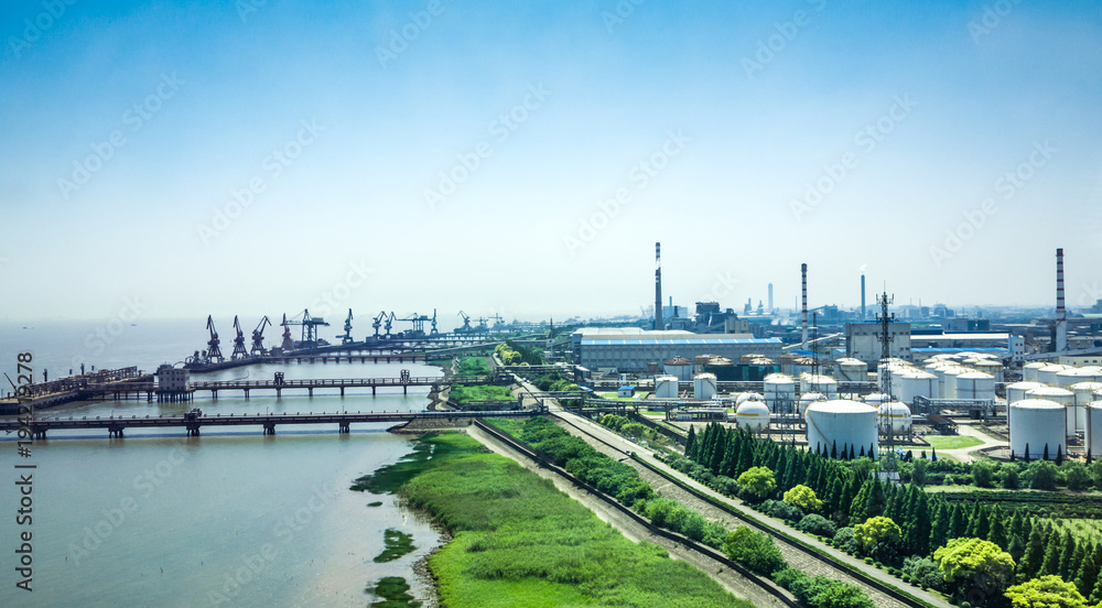 Crude oil tanker under cargo operations on typical shore station with ...