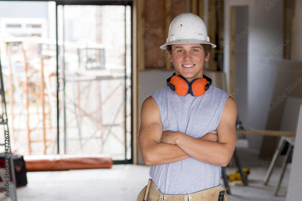portrait of young attractive builder man on his 20s posing happy ...