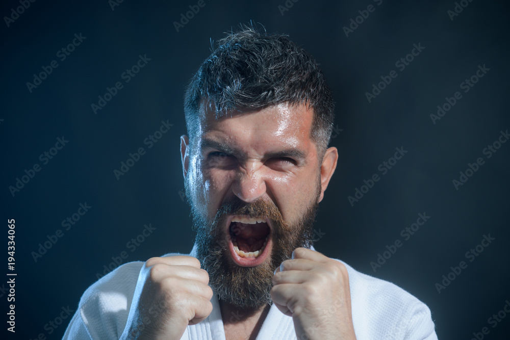Strong, angry, bearded man dressed in kimono, shaking fist, portrait a ...