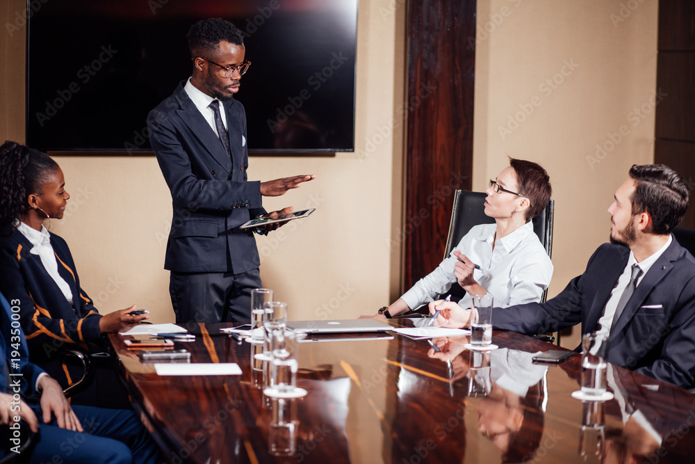 black leader of the business people giving a speech in a conference ...