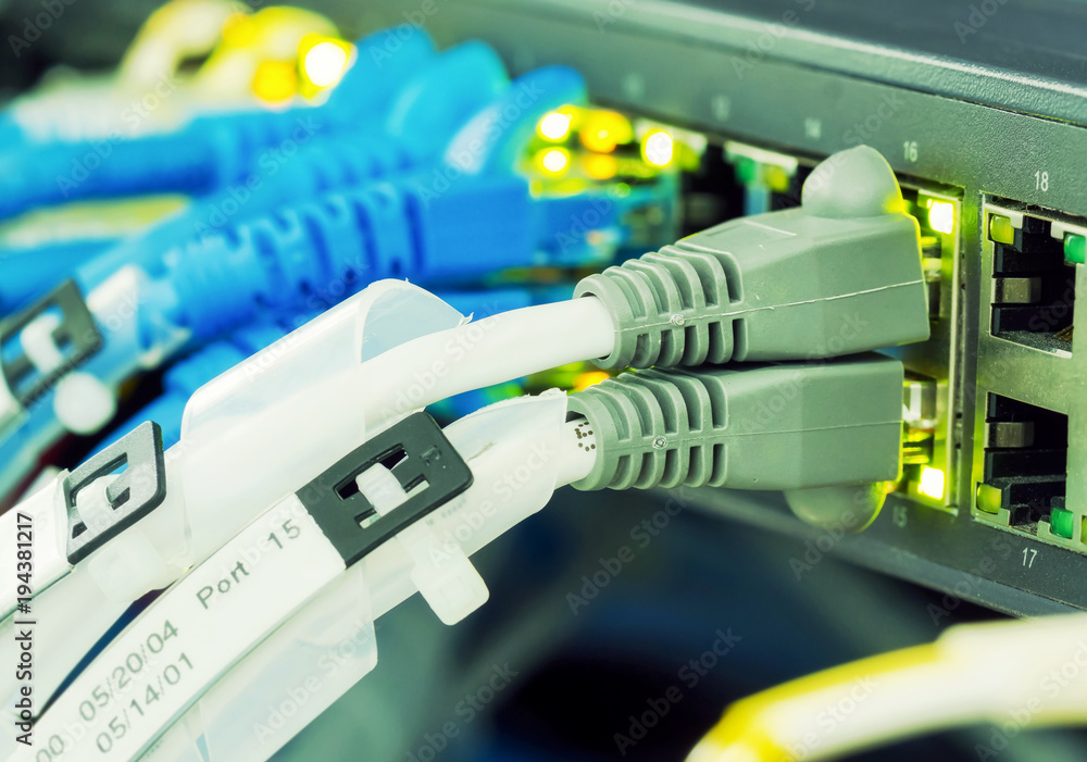 Ethernet cables Rj45 type with grey connector plug in to equipment ...