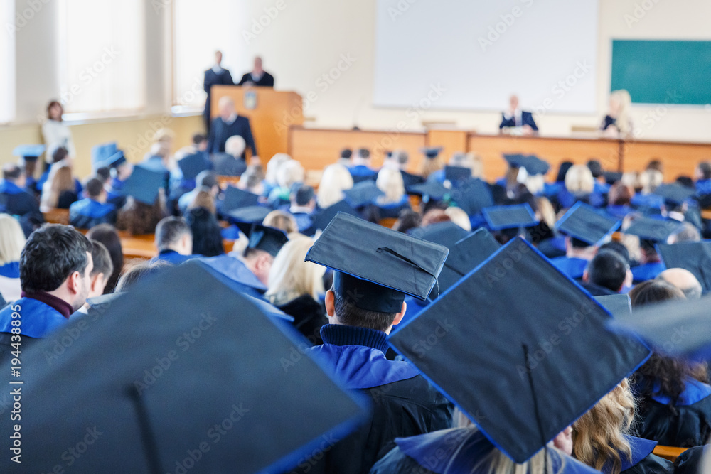 Back view of square academic master caps of graduated students sitting ...