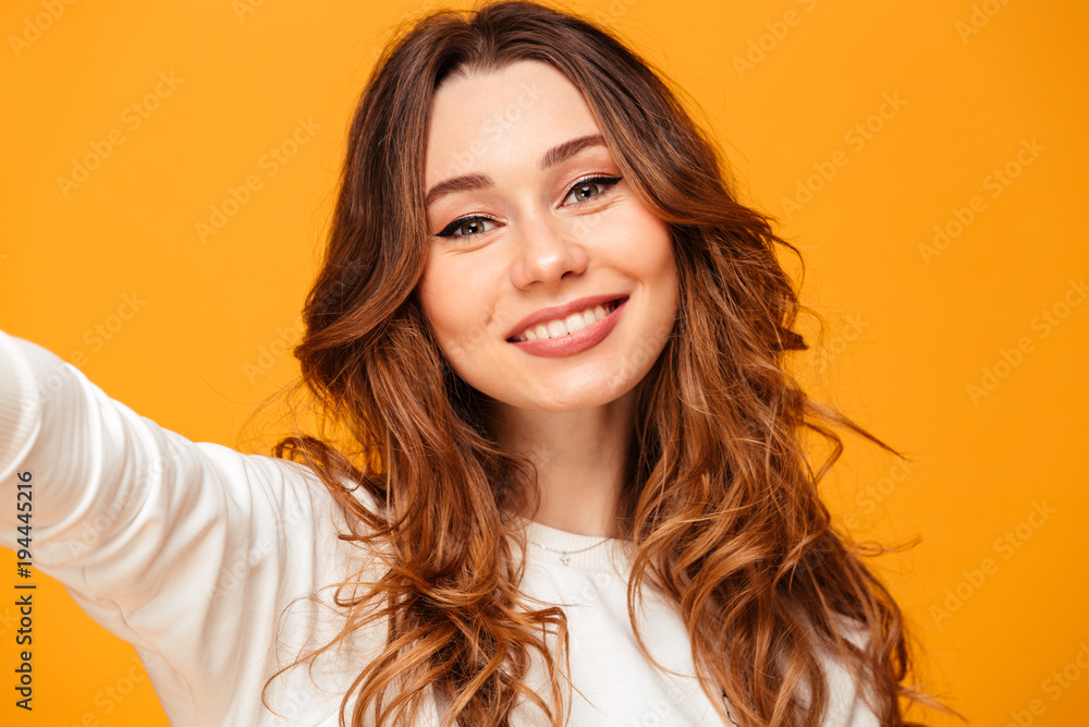 Smiling young woman make selfie. Stock Photo | Adobe Stock