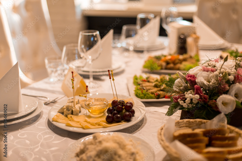 banquet hall of the restaurant, beautifully decorated tables with food ...