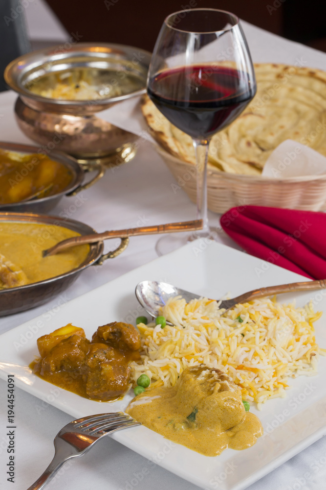 Indian curry food spread on a fancy dinner table with rice, laccha ...