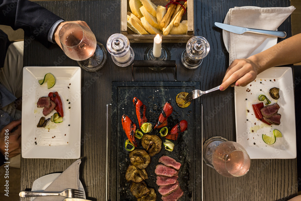 Man and woman eating during candlelight lunch.Overhead top view ...