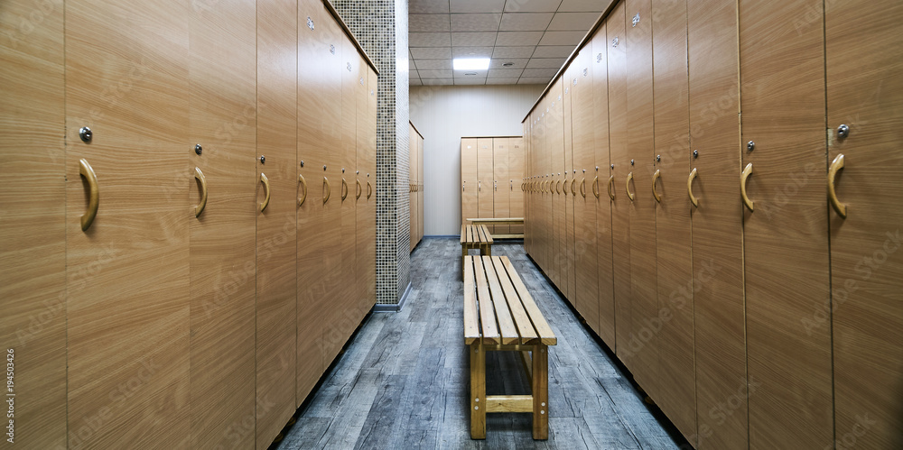 Interior of locker room in the gym. Sportsmen locker room with bench ...
