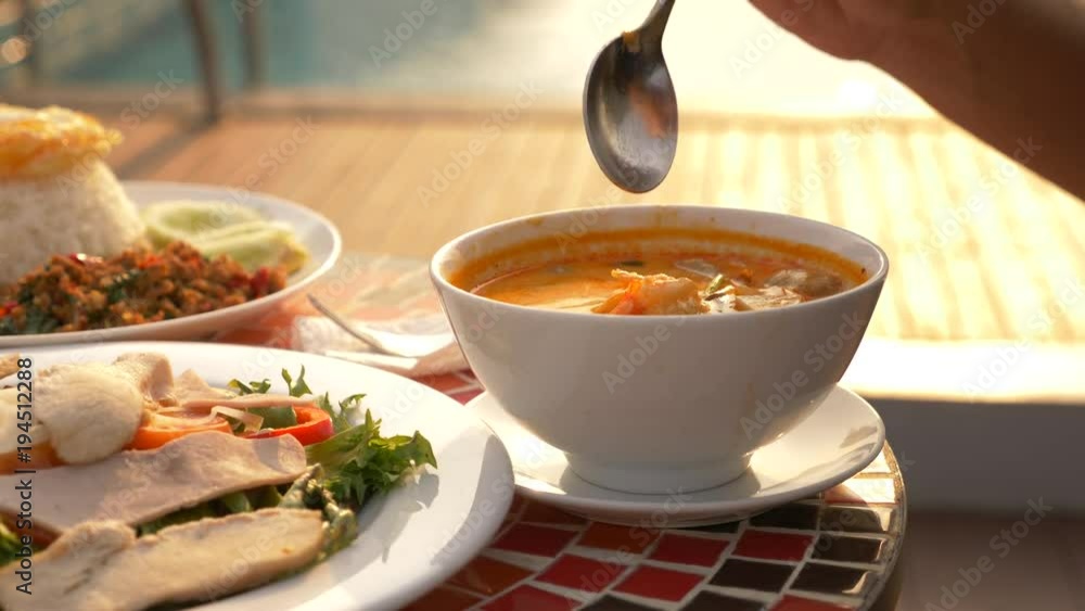Shrimp soup is a Thai dish with a sour and spicy taste. the man is ...