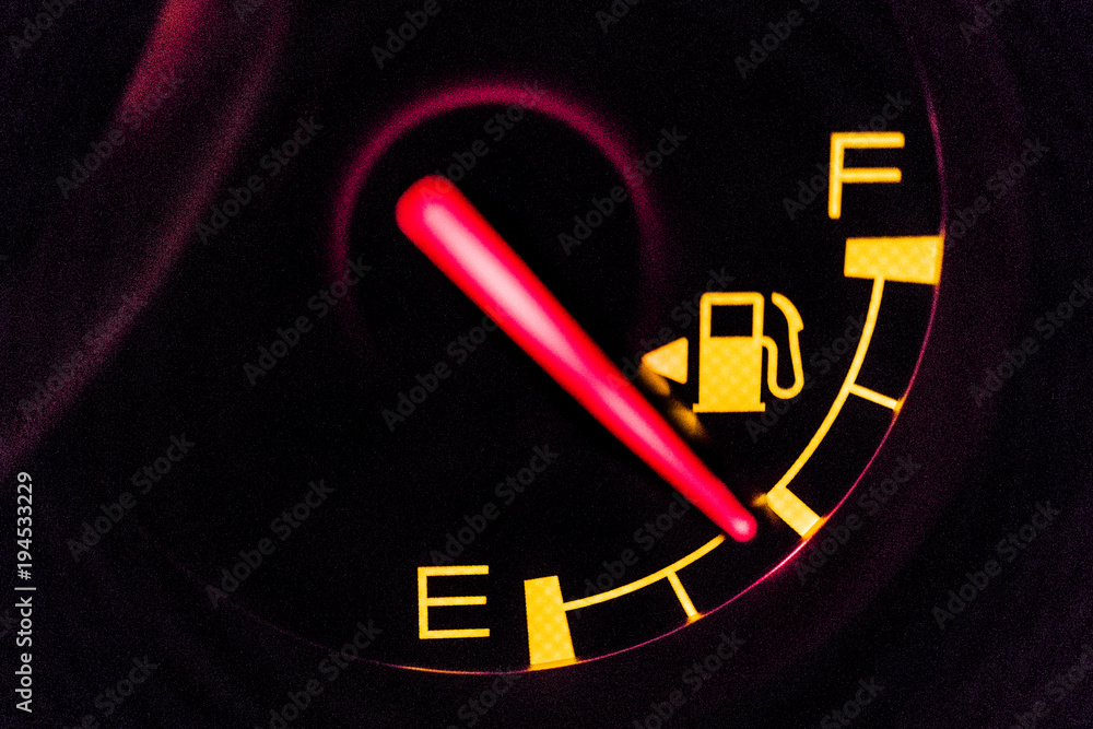 Gasoline gauge display half full of fuel. The dashboard lit up in ...