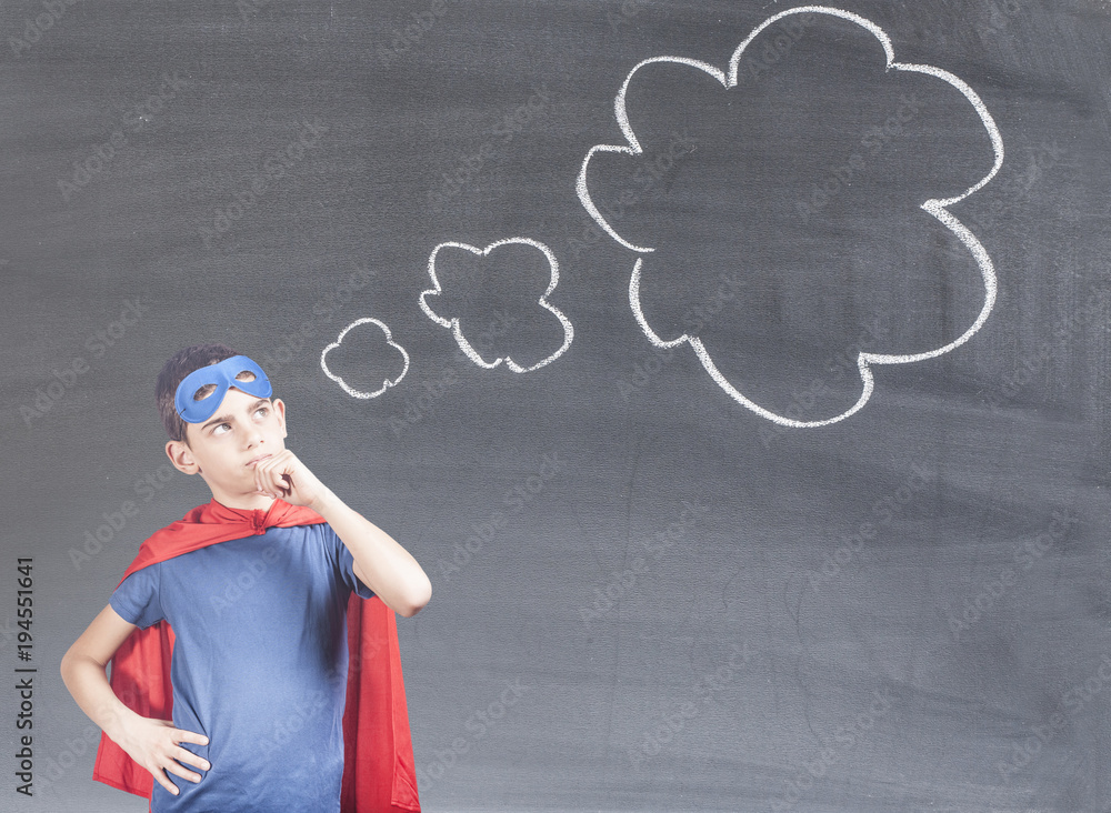 Litlle super hero boy thinking hard. New ideas, innovation and ...