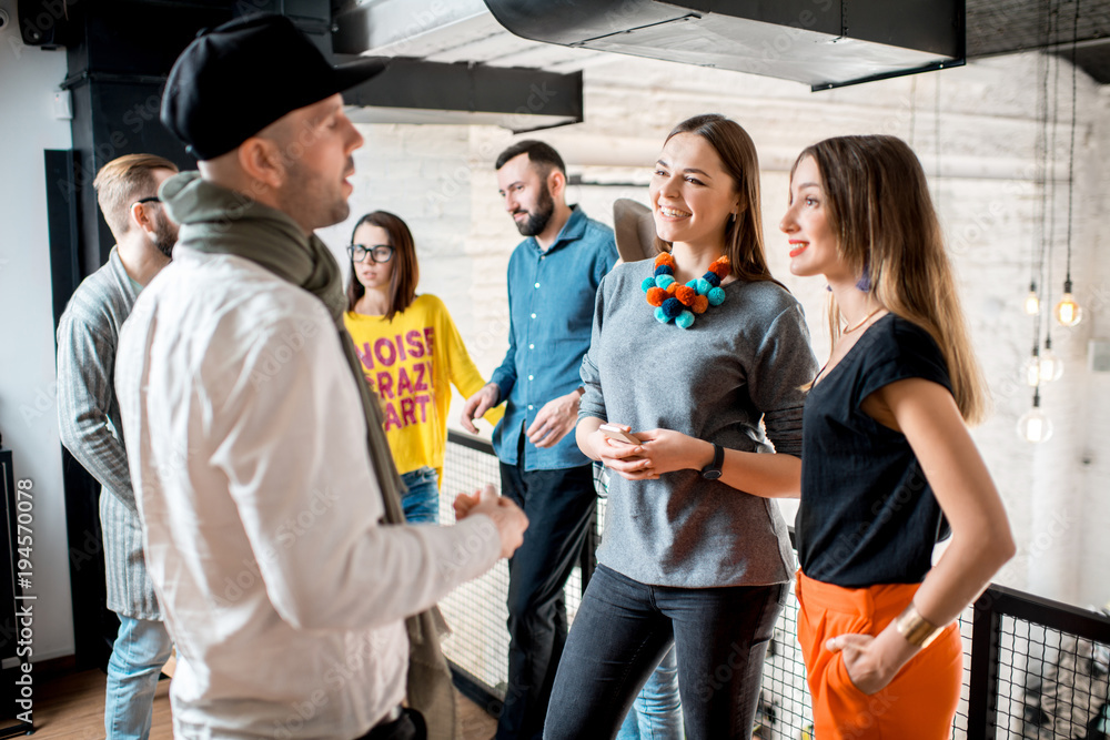 Group of friends dressed casually talking together during the coffee ...