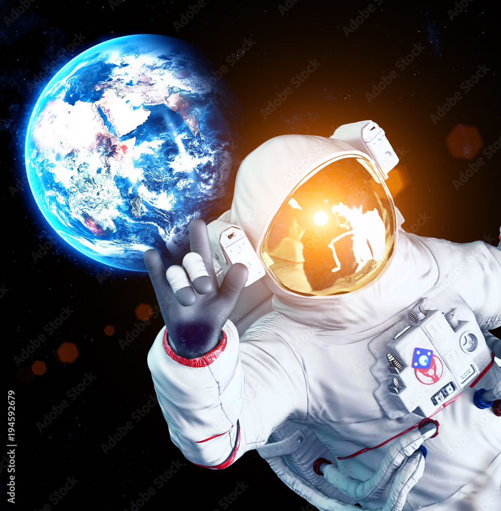 Astronaut in space with raised hand and earth in background Stock Photo ...