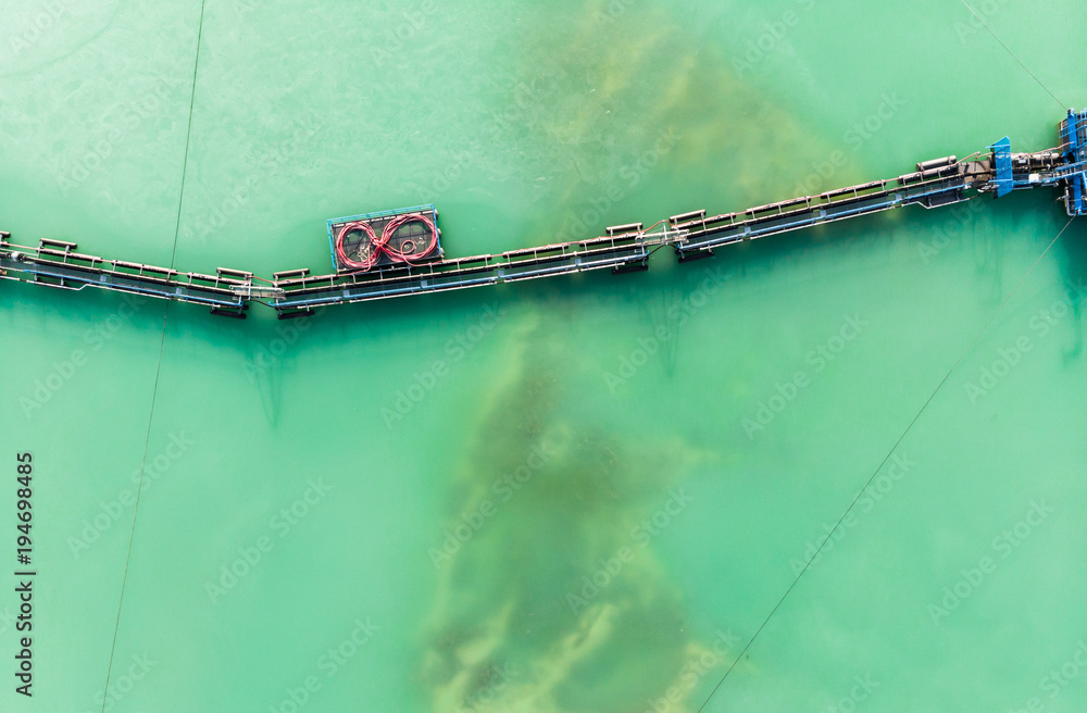 Aerial view of the long boom of a suction excavator in a quartz quarry ...