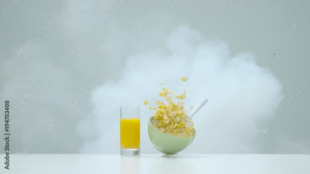Bowl with milk and cereal and a cup of orange juice exploding, Ultra ...