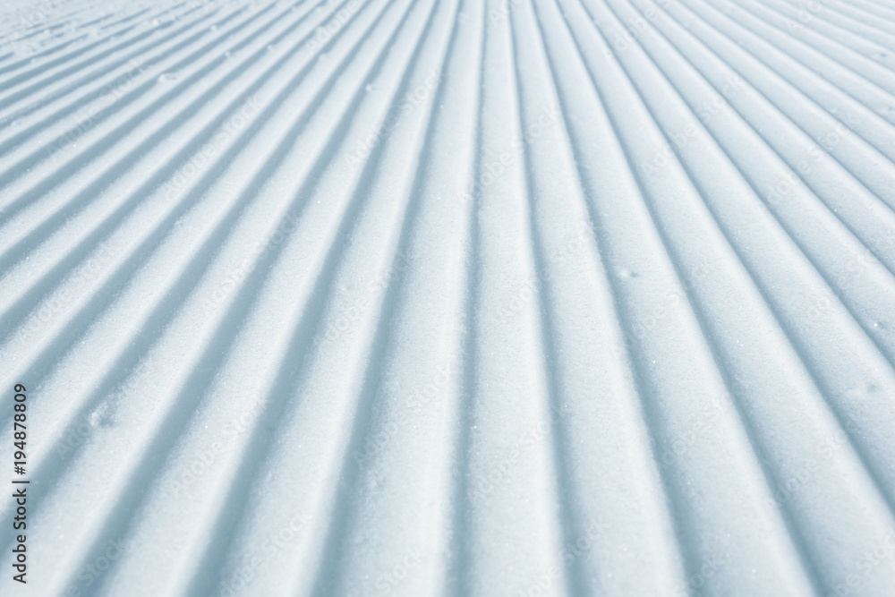 Geometry track lines on a ski slope left by a snowcat as a texture ...