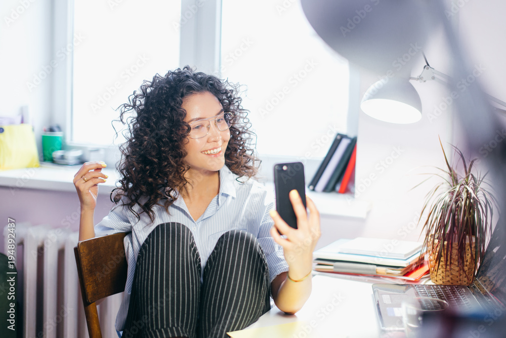 young girl with glasses boasting about her curly hair to her friend ...