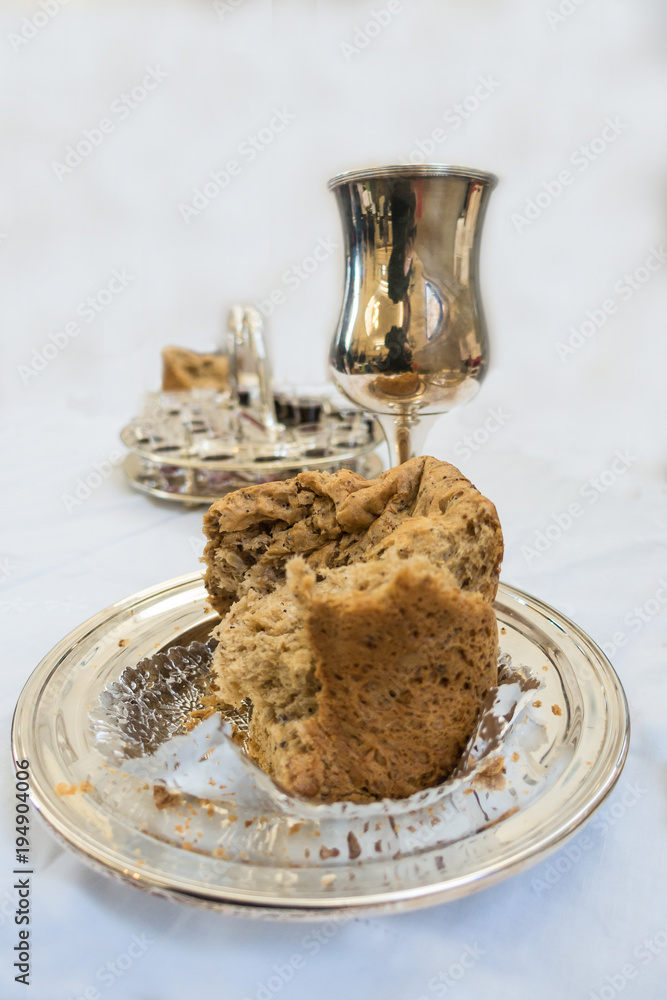 A bread and silver chalice holding wine form part of the act of Holy ...