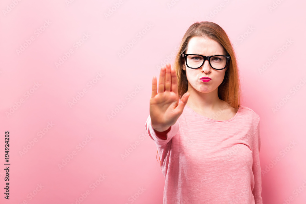 Young woman making a rejection pose on a solid background Stock Photo ...