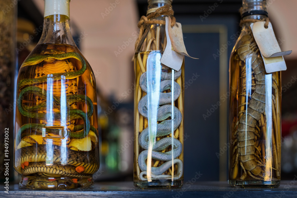 Thai traditional liquor with pickled snakes, cobra, centipede and herb ...