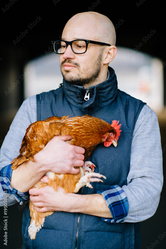 Strange unusual bald beardy man with serious senseless face in glasses ...