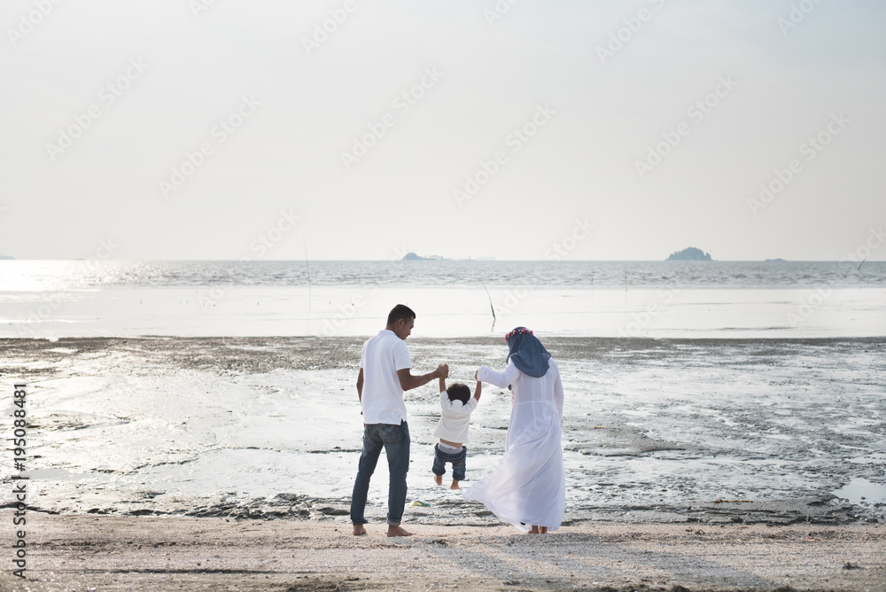happy family having fun time together at the beach located in Pantai ...