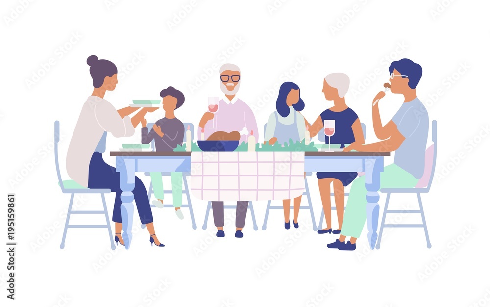 People sitting at table decorated with candles, eating food, drinking ...