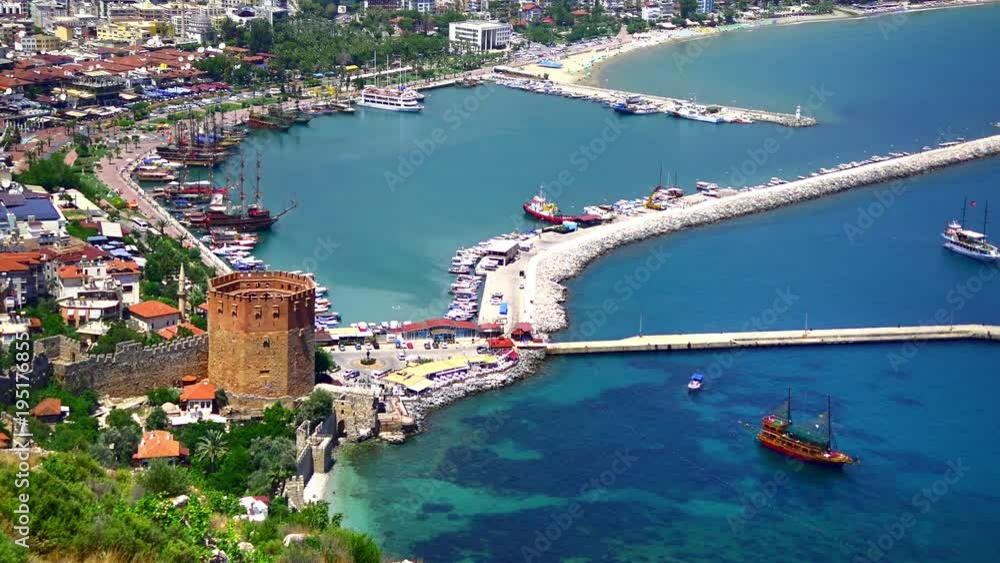 Alanya Harbor and Red Tower with lined-up tour boats on the marina ...