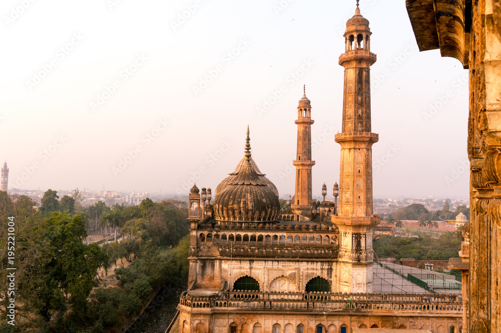 domed roof and towers of Asfi mosque shot at sunset from the rooftop of ...
