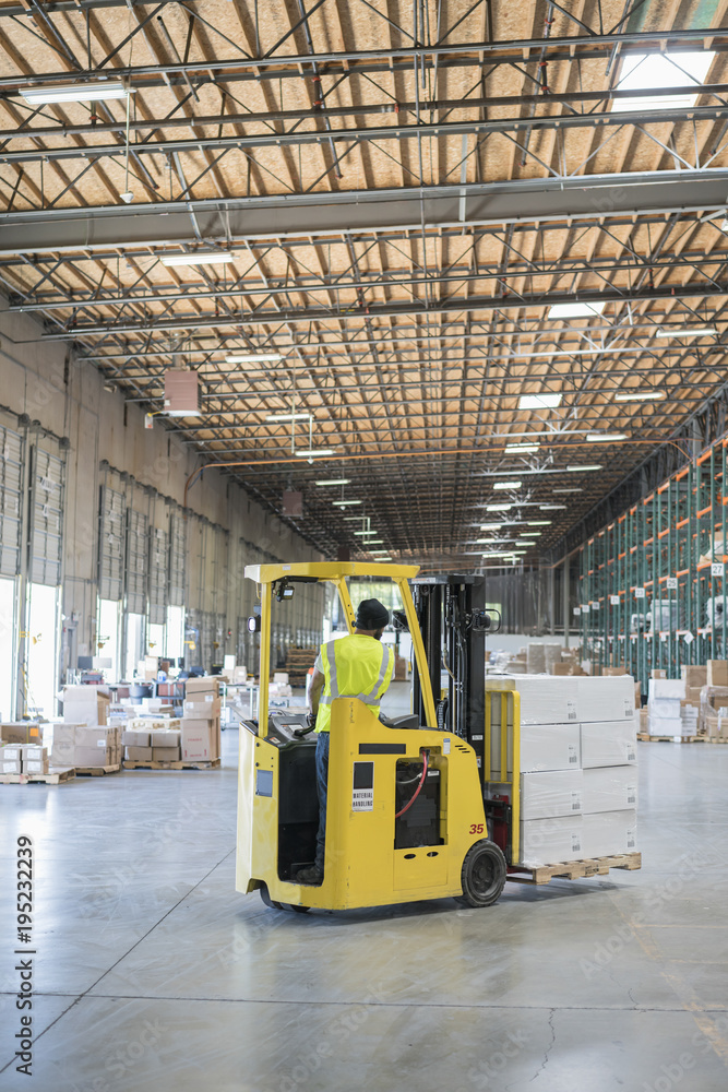 Forklift in a warehouse Stock Photo | Adobe Stock
