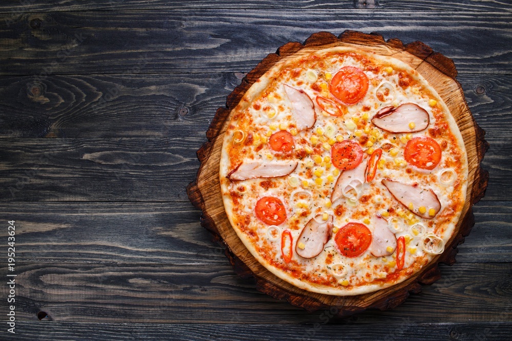 Appetizing pizza with smoked chicken fillet, sweet corn and tomatoes ...