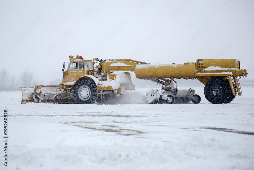 Clearing airport from snow during snow storm. clearing runway from snow ...