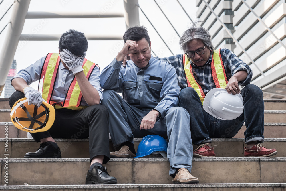 Unhappy engineer sitting on building stairs at construction site, They ...