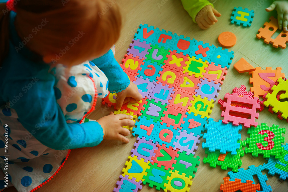 kids playing with puzzle, learning letters and numbers Stock Photo ...
