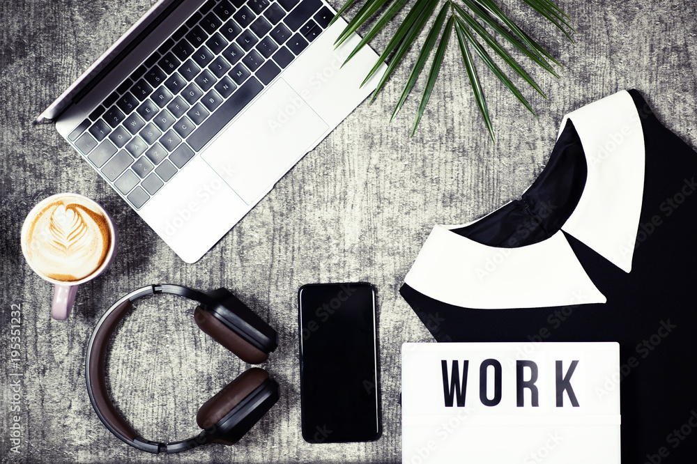 Top view work items on dark wood background laptop computer, headphones ...