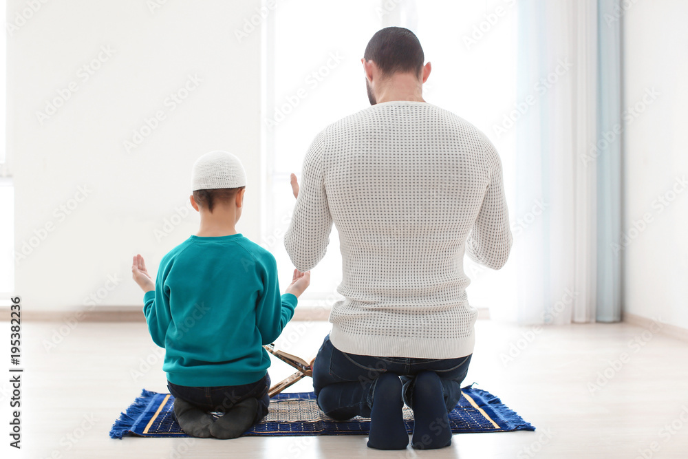 Muslim father and son praying together, indoors Stock Photo | Adobe Stock