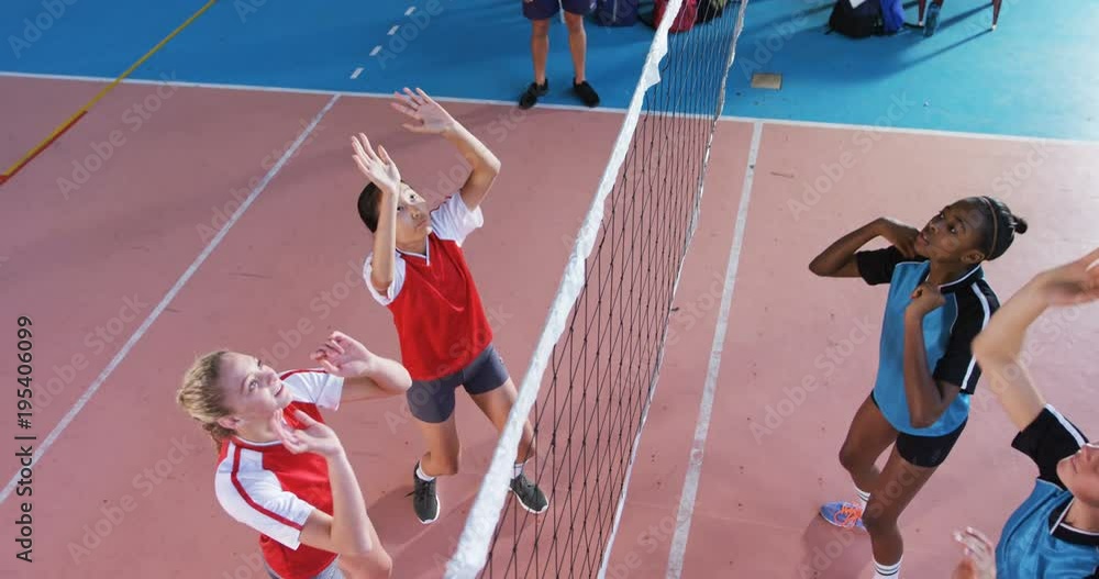 Female volleyball players playing volleyball in the court Stock Video ...