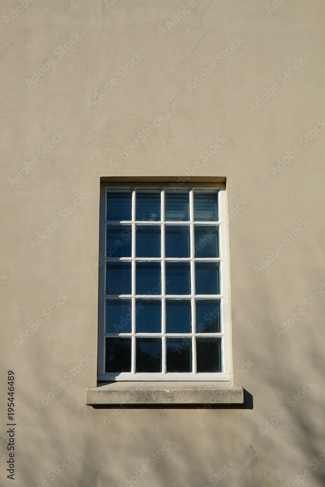 Big square window with small glazing pattern made of many mullions in a ...