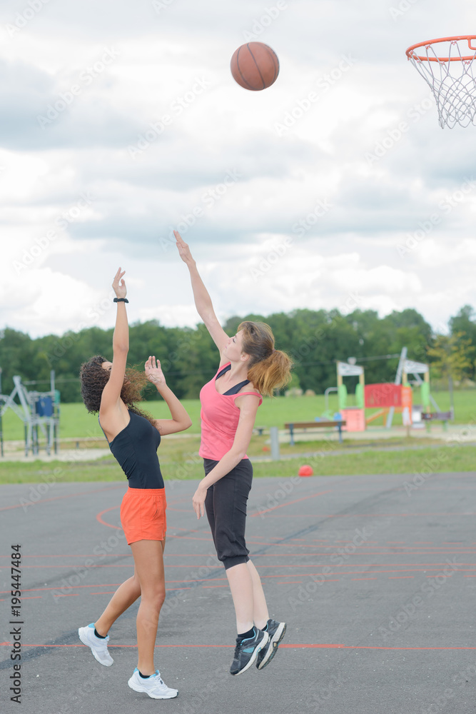 players practising netball in playground Stock Photo | Adobe Stock
