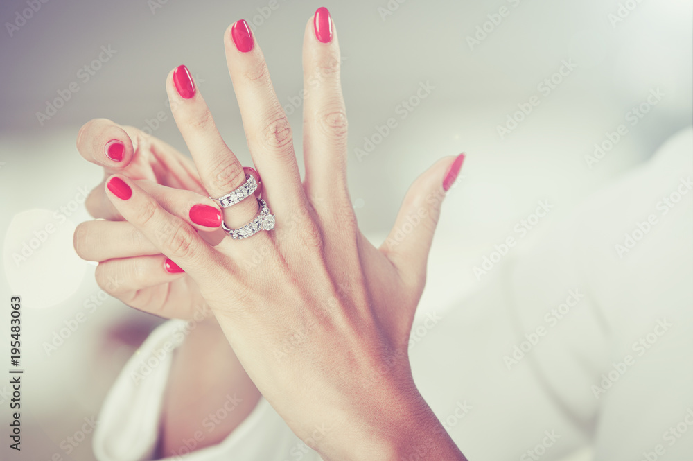 female hands with red nails and elegant diamond rings. Stock Photo ...