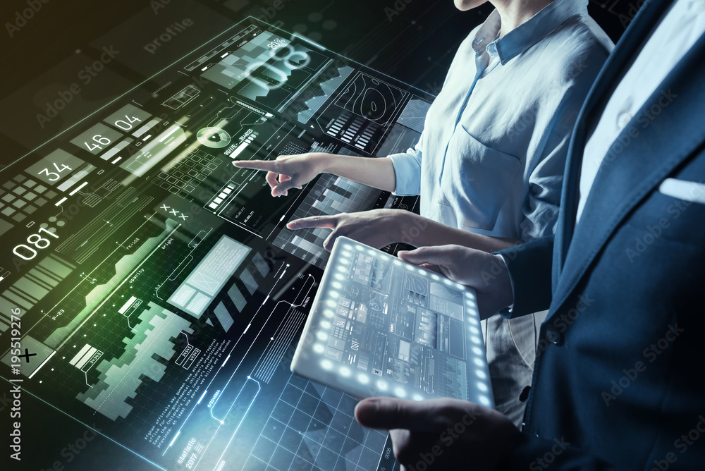 Modern devices. Calm experienced elegant programmer holding a ...