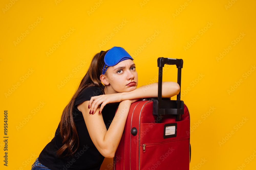 sad woman sitting with a large suitcase, vacation Stock-Foto | Adobe Stock