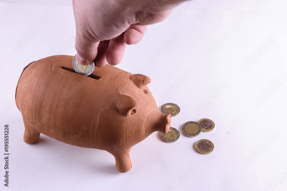 Foto de hand tossing a two-euro coin into a mud bank and five euro ...
