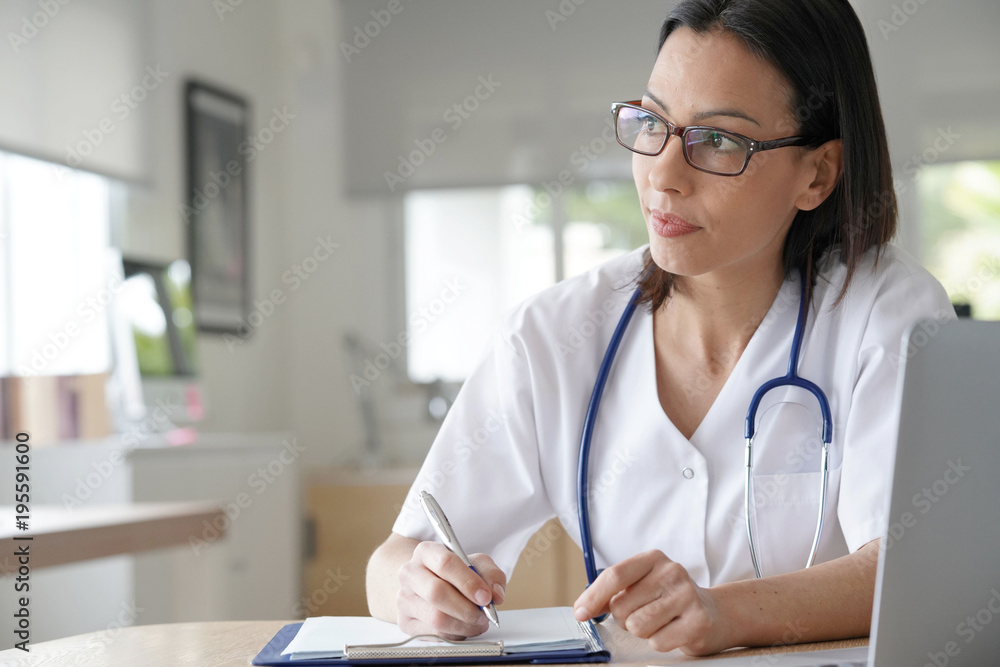 Portrait of nurse writing prescription Stock Photo | Adobe Stock