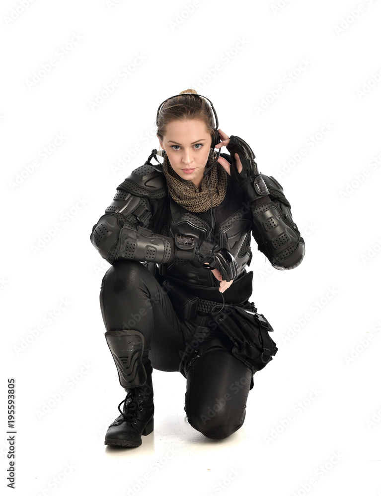 full length portrait of female soldier wearing black tactical armour ...