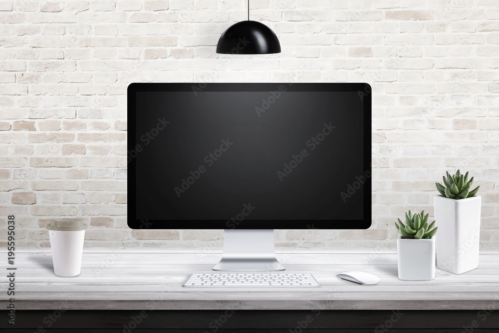 Computer display on modern office desk with plants nad plastic cup of ...